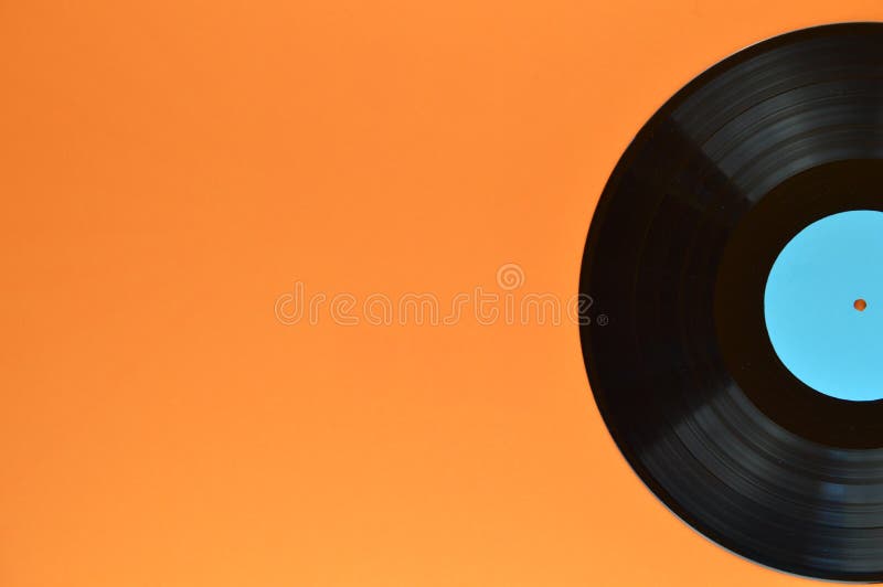 Half Black Vinyl Record on Orange Background Stock Image - Image of ...