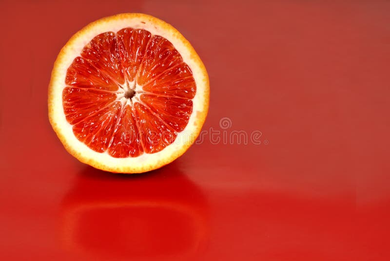 Half of a Blood Orange on a Red Background Stock Photo - Image of ...