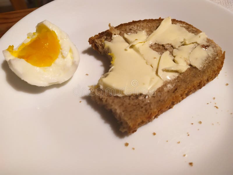 Half of a Boiled Egg and a Piece of Brown Bread, Buttered Stock Image - Image of butter, piece ...
