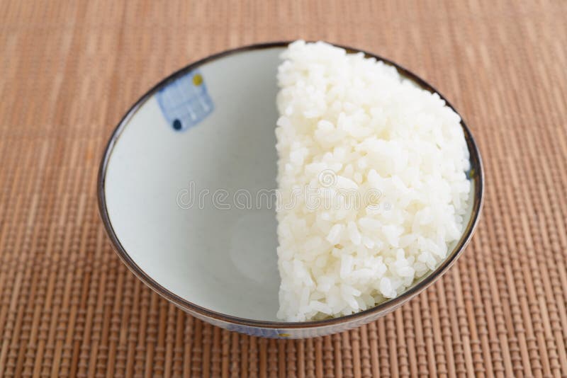 Half a bowl of rice. stock photo. Image of diet, isolated - 143220504