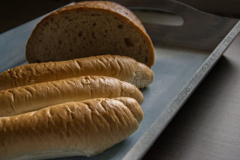Half Bread and Rolls on the Blue Wood Plate Stock Photo - Image of ...