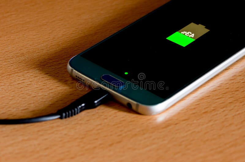 A Half-charged Mobile Phone on Top of the Table Stock Image - Image of ...