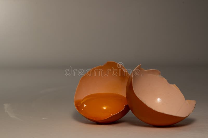 Half of a Chicken Egg Shell with Yolk and an Empty Half. Stock Image ...