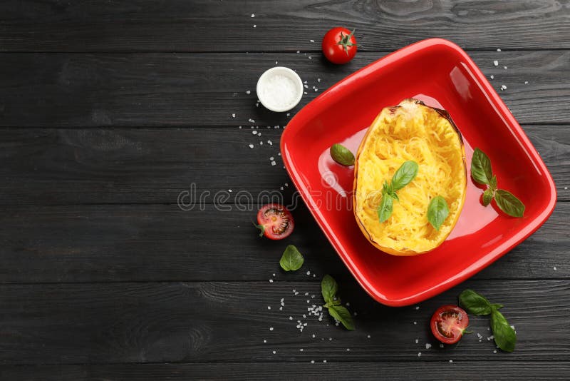 Half of Cooked Spaghetti Squash in Baking Dish and Ingredients on Black ...