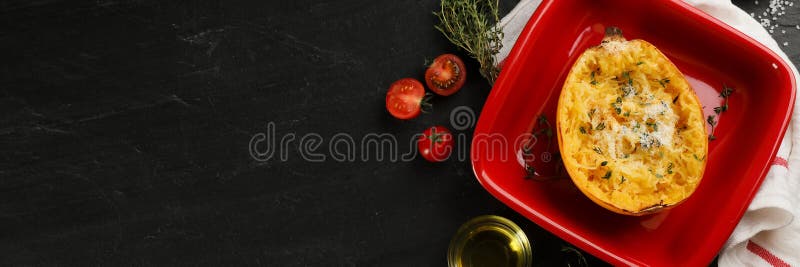 Half of Cooked Spaghetti Squash with Cheese in Baking Dish on Black ...
