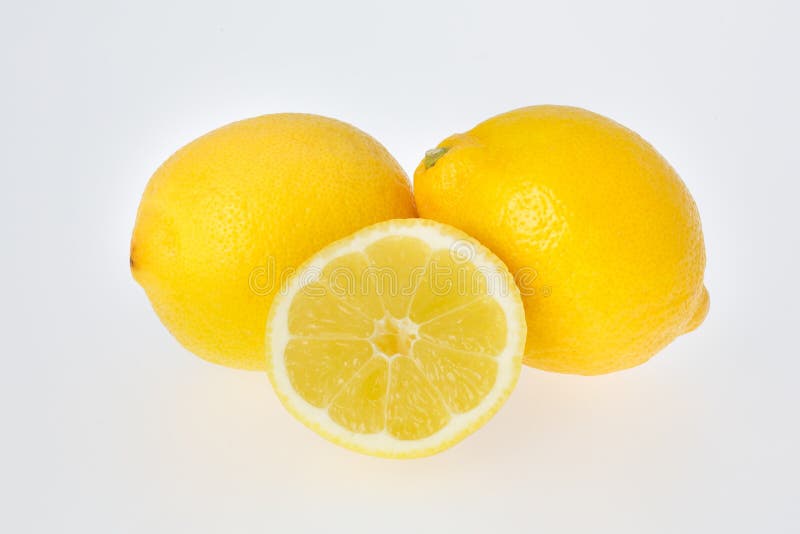 A Cut Lemon in Front of Two Lemons Stock Photo - Image of vegetables ...