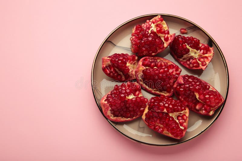 Half-cut Pomegranate with Seeds in Plate on Pink Background. Top View ...