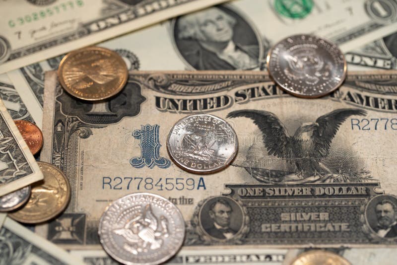 Half Dollar and One Dollar Coins on Top of 1 Dollar Banknote Stock ...