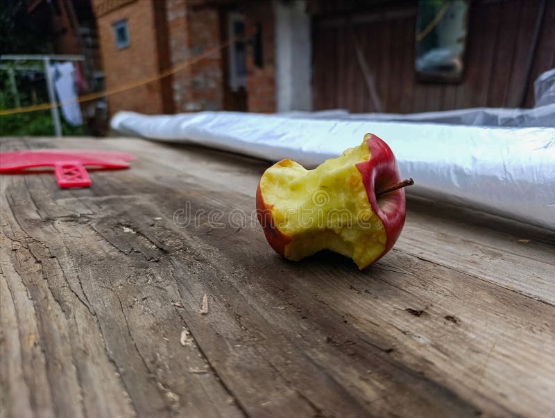 A Half Eaten Apple Sitting on Top of a Wooden Table Stock Photo - Image ...