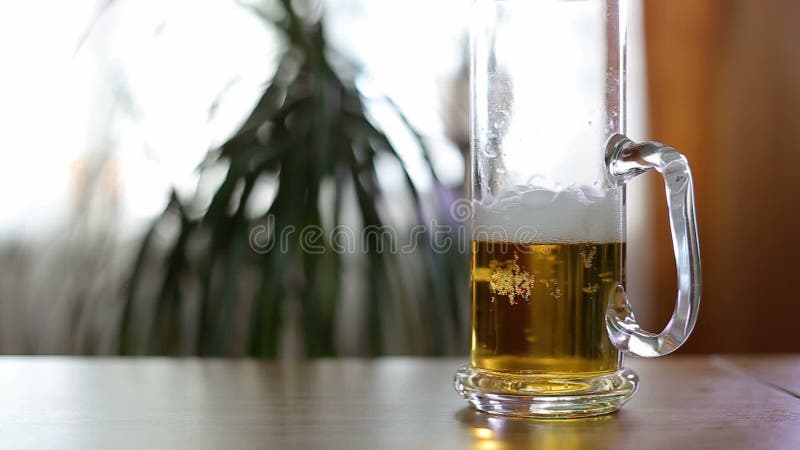 Half Empty Beer Mug on Table Stock Footage - Video of color, froth ...