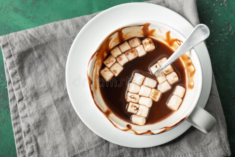 Half Empty Cup of Hot Chocolate with Marshmallows on Color Table Stock ...