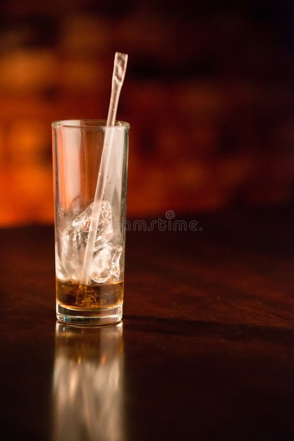 Half Empty Glass of Cola with Chewed Straw and Copyspace Stock Image ...