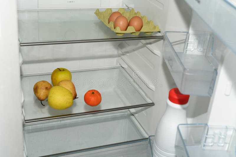 Half-empty Open Refrigerator, Some Fruits, Three Eggs and a Bottle of ...