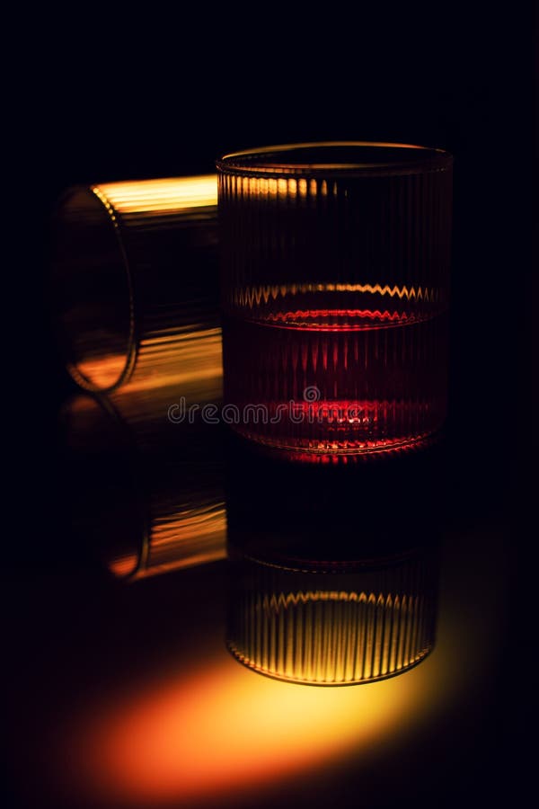 Half-filled Glass Against a Gradient Backdrop, Light through Ridges ...