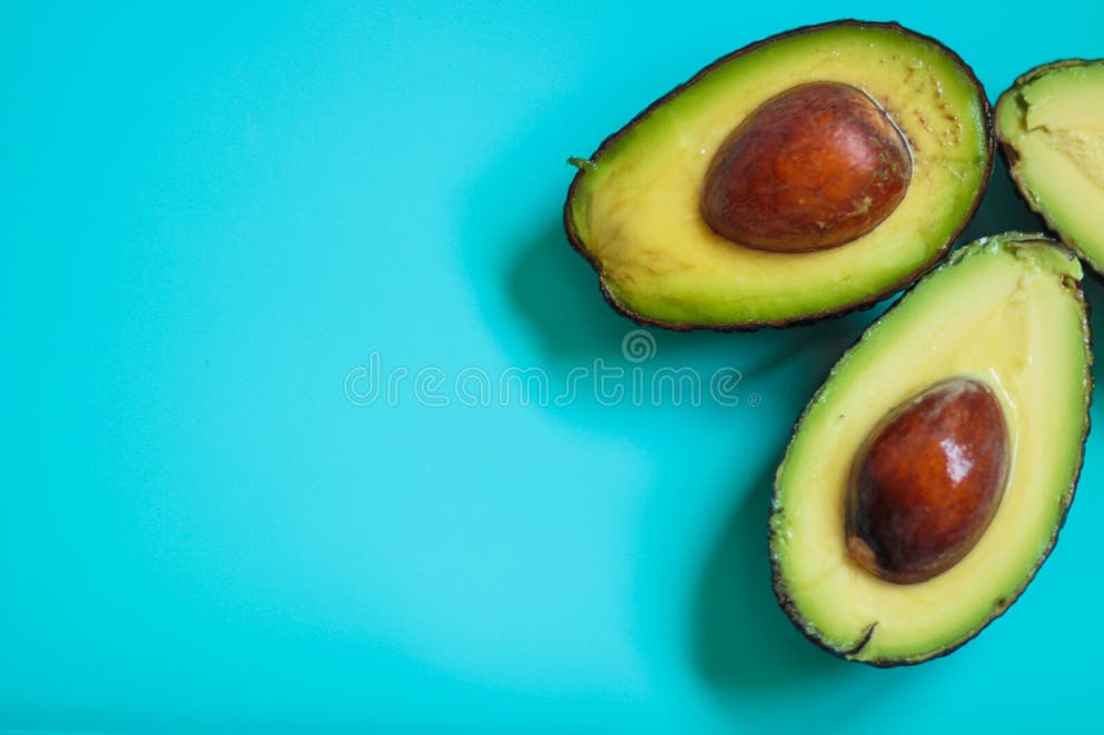 Half of Fresh Green Avocado on Blue Background Stock Photo - Image of ...