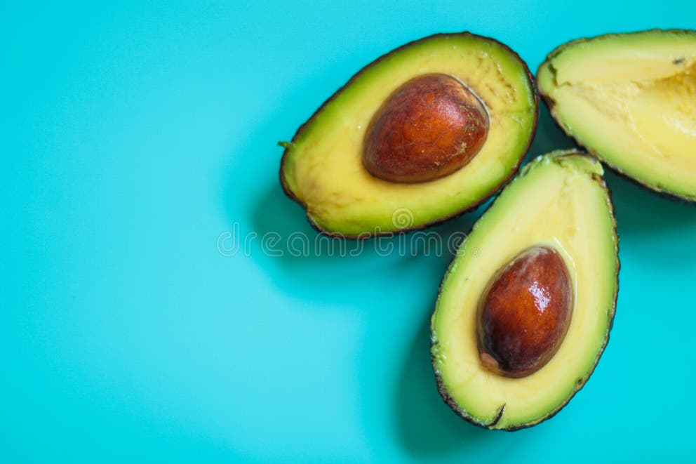 Half of Fresh Green Avocado on Blue Background Stock Photo - Image of ...