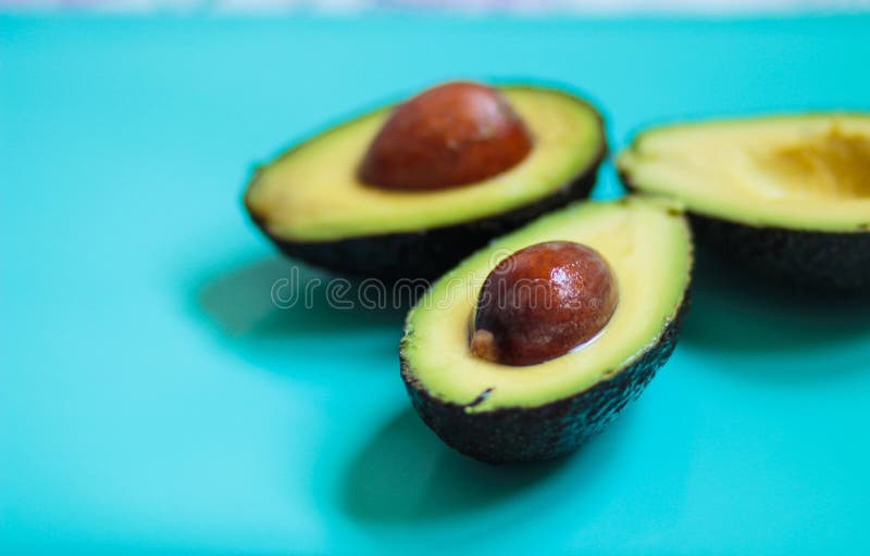 Half of Fresh Green Avocado on Blue Background Stock Image - Image of ...