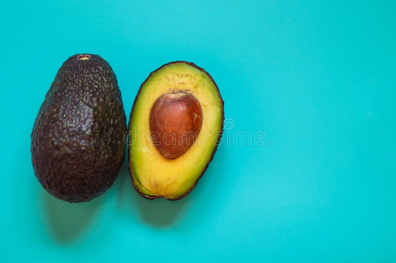 Half of Fresh Green Avocado on Blue Background Stock Photo - Image of ...