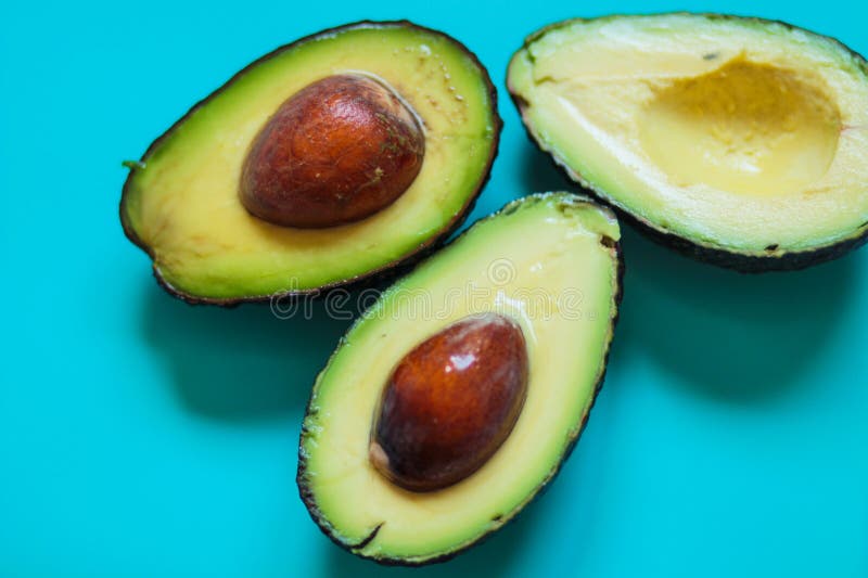 Half of Fresh Green Avocado on Blue Background Stock Image - Image of ...