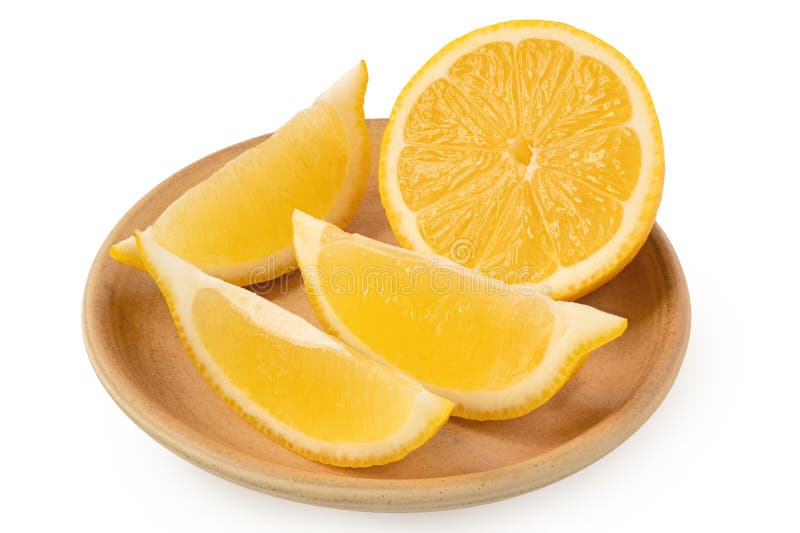 Half of Fresh Lemon and Three Segments on Rustic Plate Stock Photo ...
