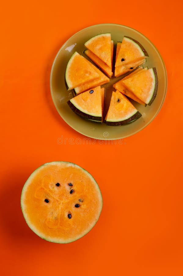 Half of Fresh Ripe Orange Watermelon and Slices at Plate Around Orange ...