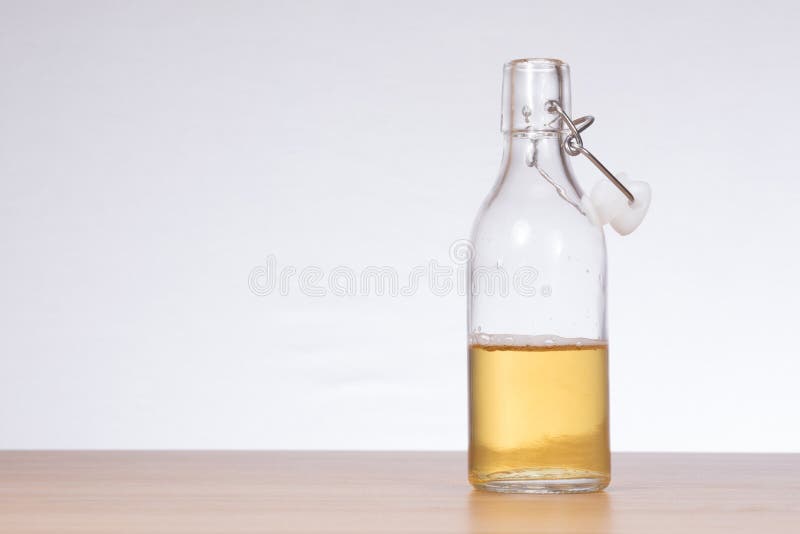 Half Full Open Glass Lever Bottle of Beer on Table Stock Image - Image ...