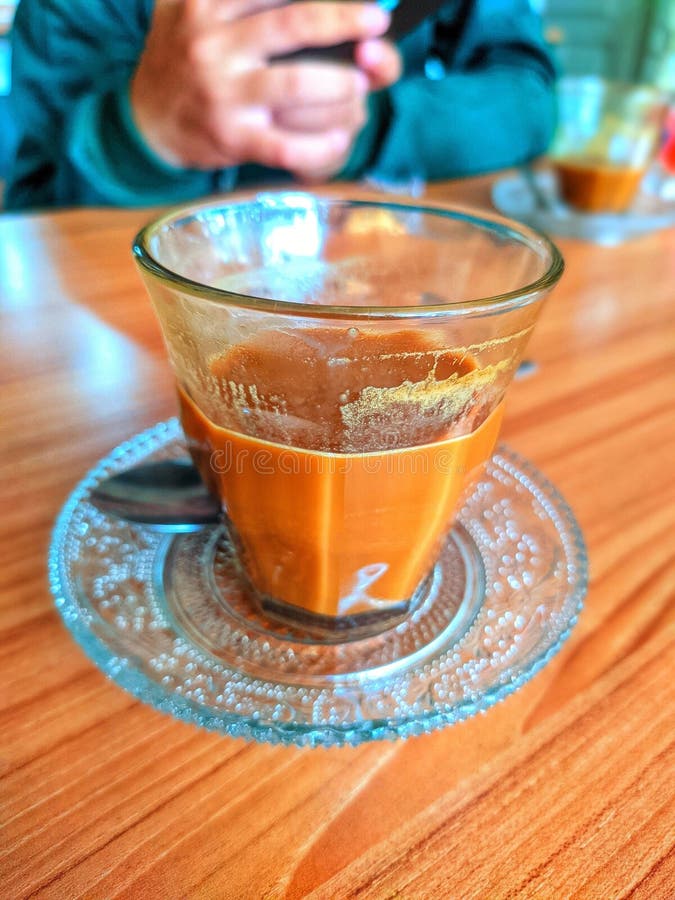 Half Glass of Cappuccino on Front a Man with Gadget Stock Image - Image ...