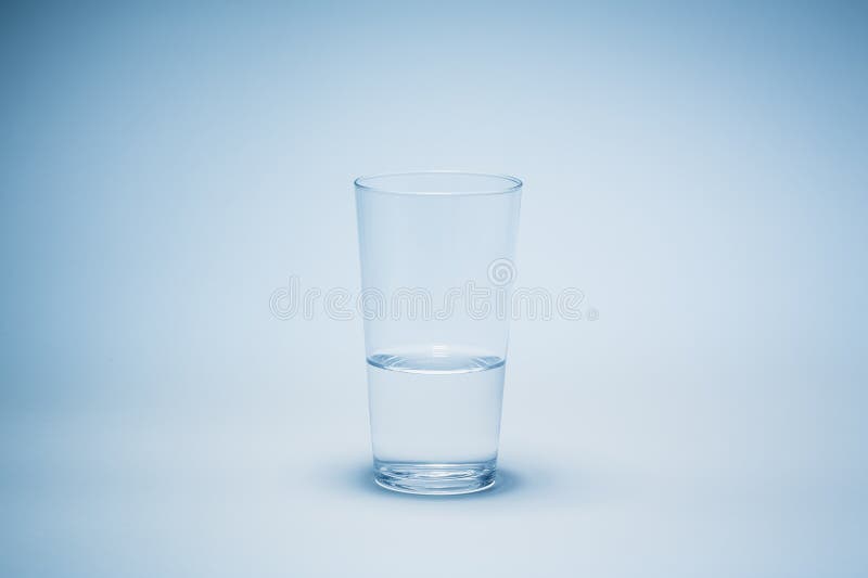 Half a Glass of Water with Blue Background Stock Image - Image of ...