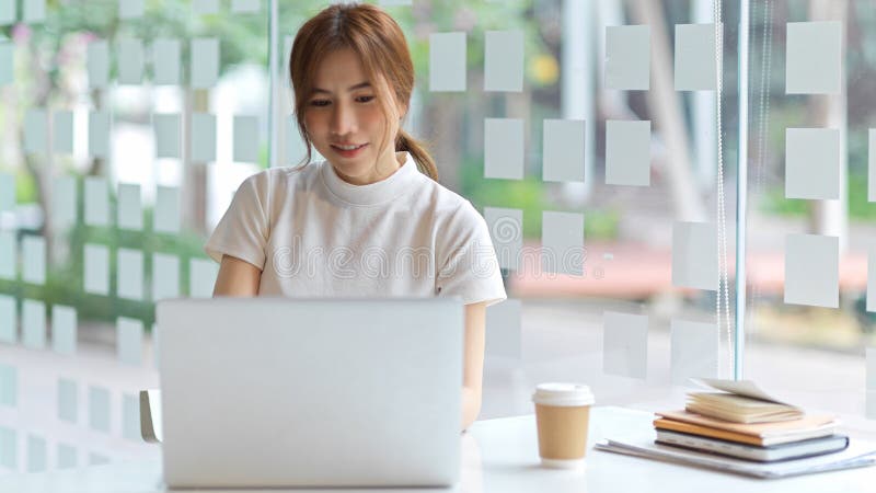 Half-length Portrait of Female Using Computer Laptop and Stationery in ...