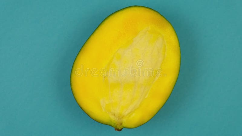 Half Mango Rotates on a Blue Background Stock Video - Video of gold ...