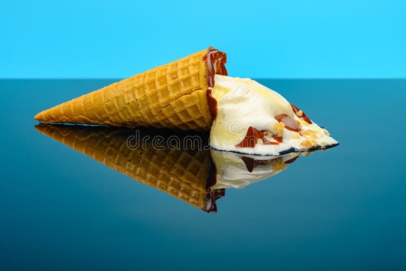 A Half Melted Vanilla Flavor Ice Cream Cone on Glass with Reflection ...