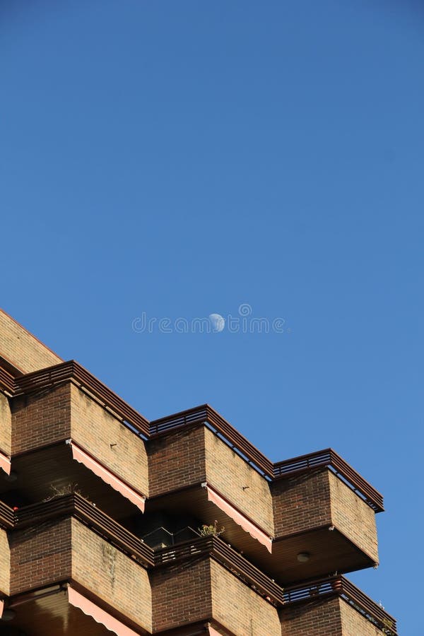 Half Moon in the Clear Blue Sky Above a Stone Building. Stock Photo ...