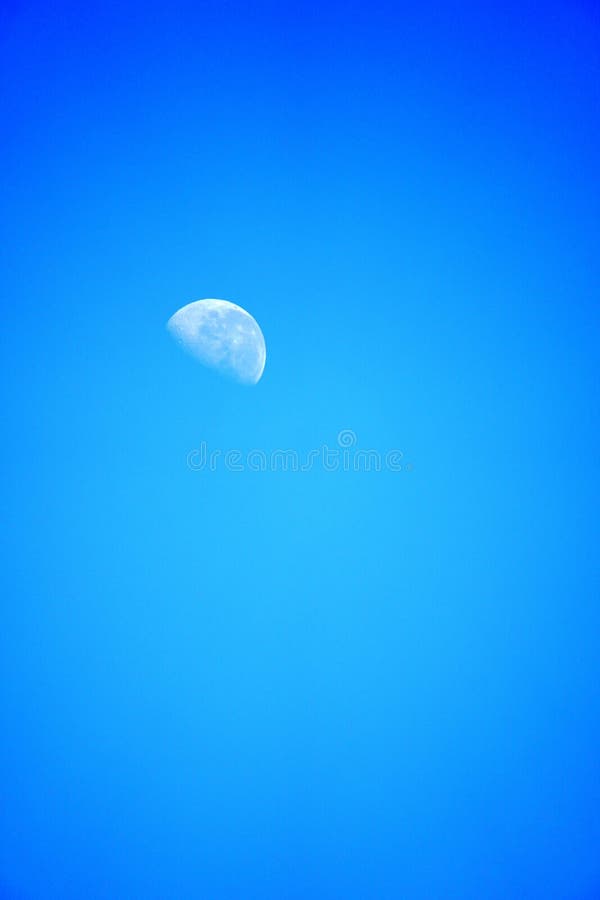 Half-moon Clearly Visible in the Morning Sky, Set Against a Backdrop of ...