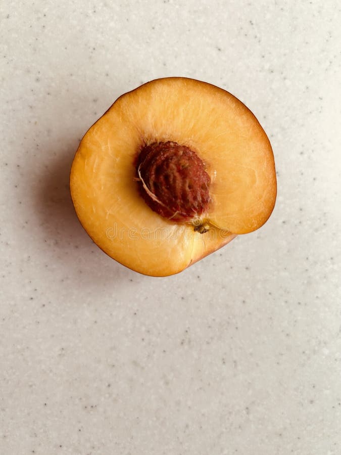 Half Nectarine with Stone on Speckled Off-white Surface. Stock Photo ...