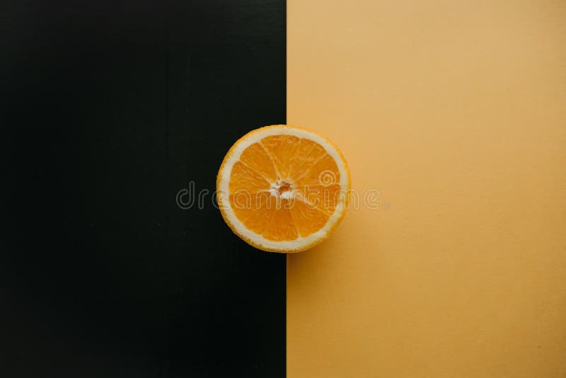 Half an Orange on a Black and Yellow Background Stock Photo - Image of ...