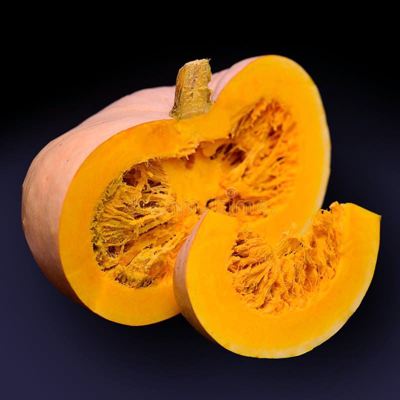 Half a Pumpkin and a Slice of Pumpkin, Unpeeled on a Dark Background ...