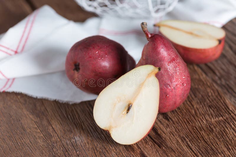 Half of Red Pear and Red Pear on Wood Table. Stock Image - Image of ...