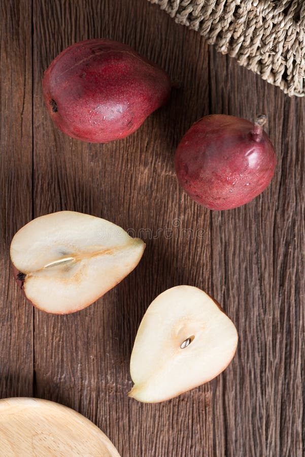 Half of Red Pear and Red Pear on Wood Table. Top View. Stock Photo ...