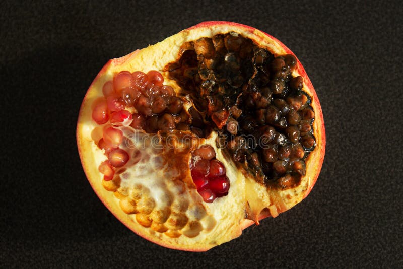 Half a Rotten Pomegranate on a Black Table Stock Image - Image of ...