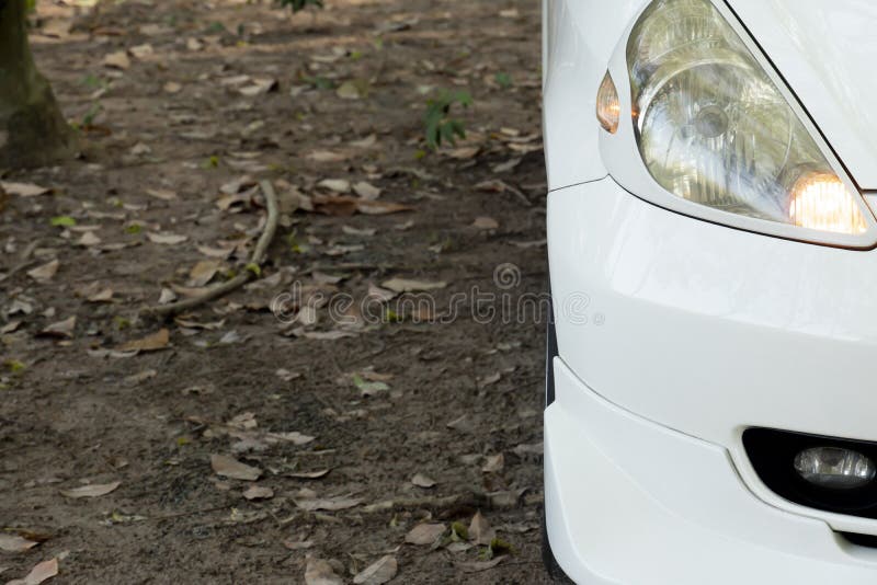 Half View of the Front of the White Car with Dimmer Lights or Turn ...