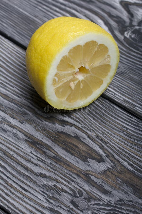 Half a Yellow Lemon on the Surface of Brushed Pine Boards Stock Image ...
