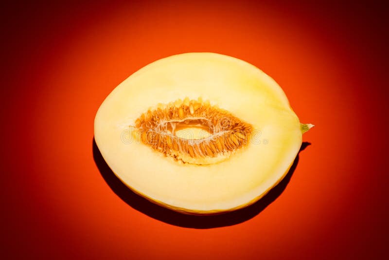 Half Yellow Melon on Dark Red Background. Top View, Dramatic Light ...