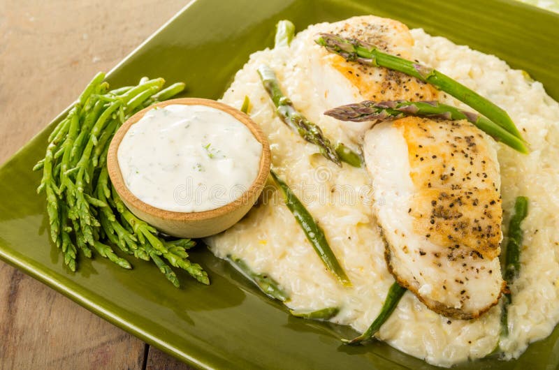 Halibut with Asparagus Risotto on Green Plate Stock Photo - Image of ...