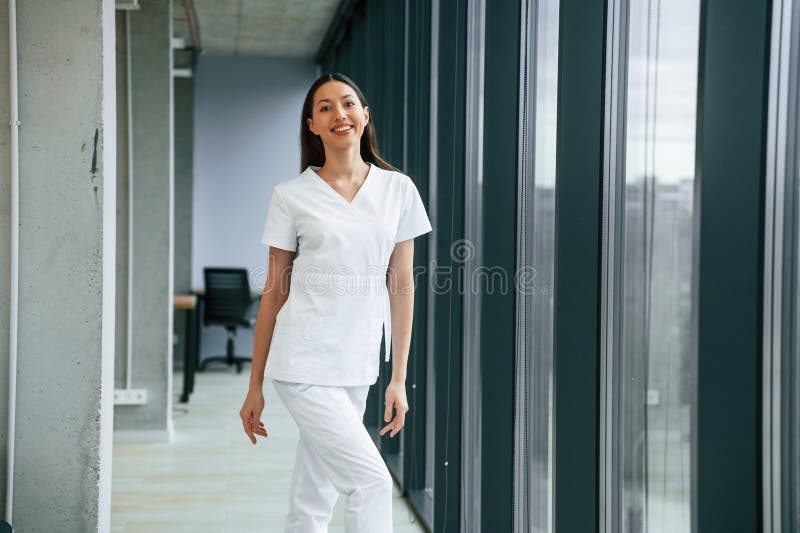 In the Hall. Female Doctor in White Coat is Indoors Stock Image - Image ...