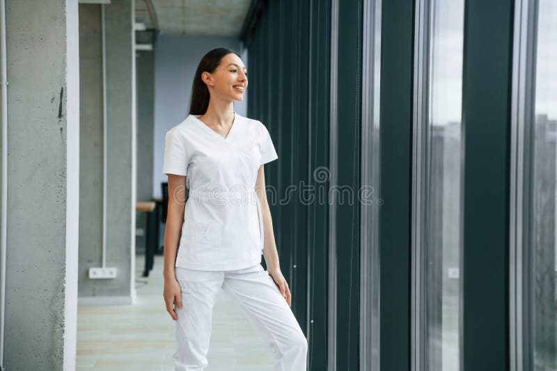 In the Hall. Female Doctor in White Coat is Indoors Stock Image - Image ...