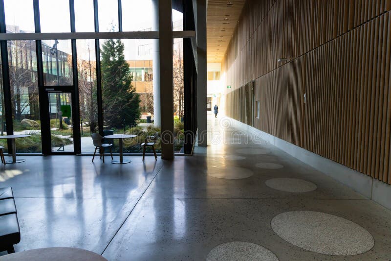 Hall in a Modern Building with Large Glass Windows and a Sitting Area ...