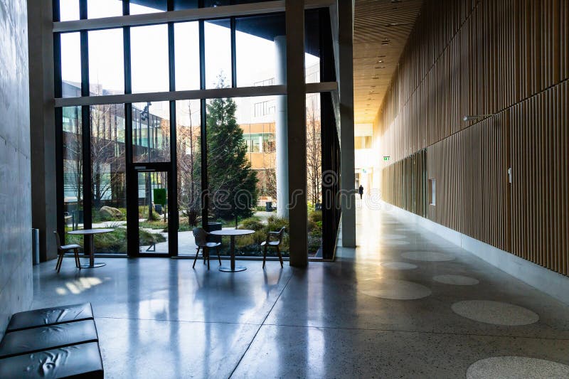 Hall in a Modern Building with Large Glass Windows and a Sitting Area ...