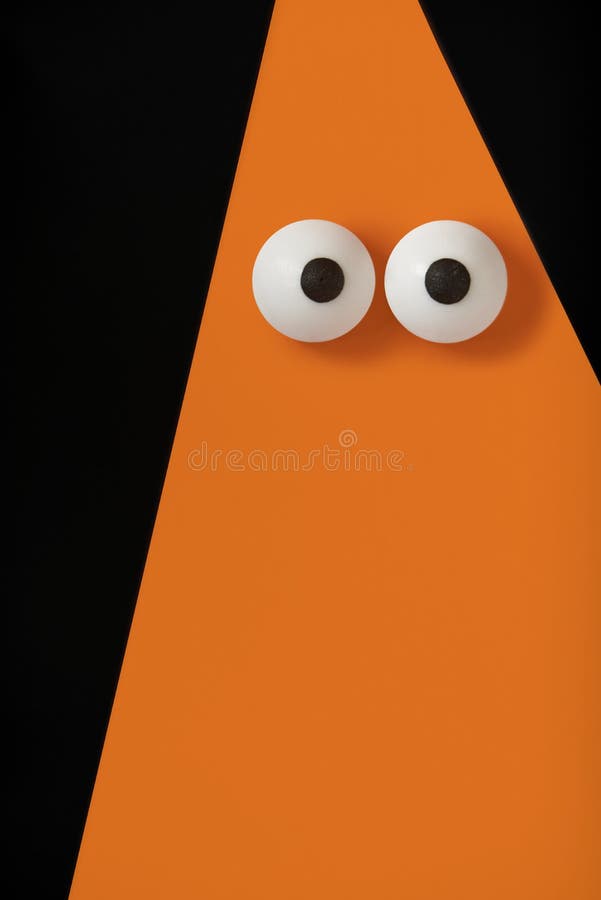 Halloween Background, Orange Ghost with Bulging Eyes on a Black Stock ...