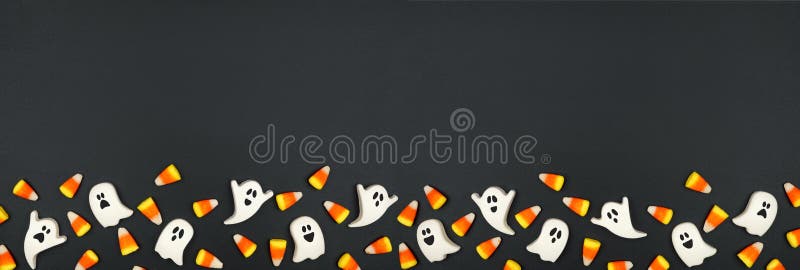 Halloween Bottom Border of Candy Corn and Spooky Chocolate Ghosts on a ...