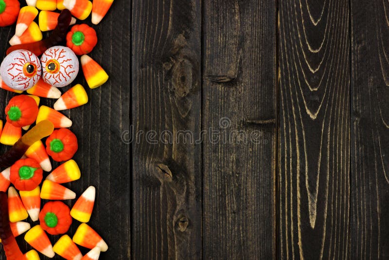 Halloween Candy Side Border Over Dark Wood Stock Photo - Image of ...